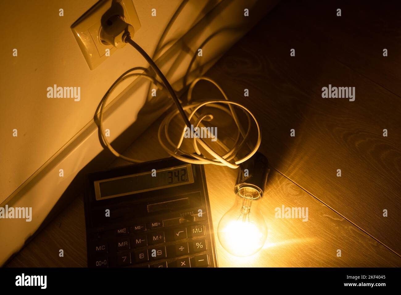 Light bulb whit calculator, electricity Stock Photo - Alamy