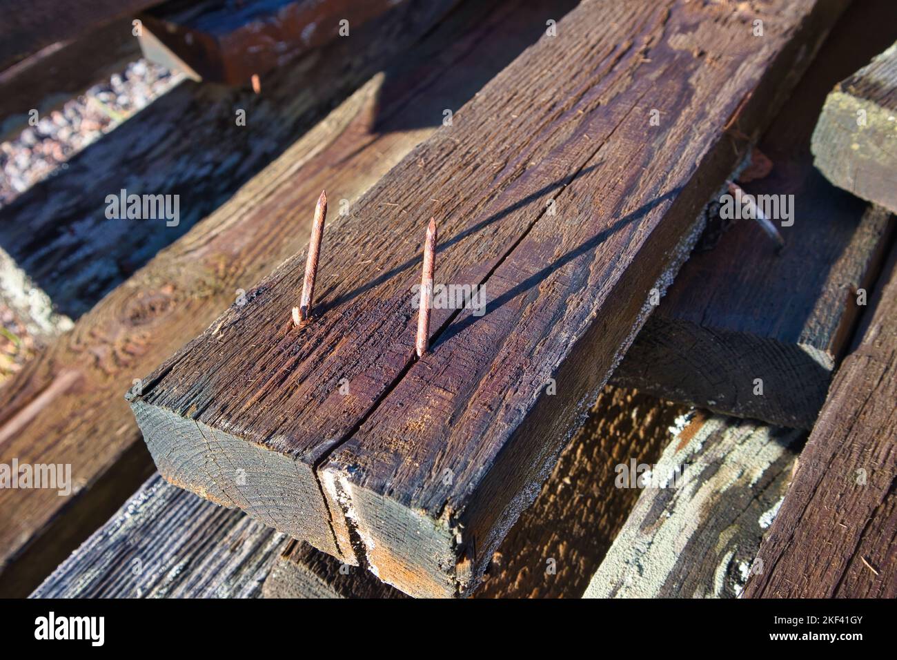 old rusty nails sticking out of wooden plank Stock Photo - Alamy