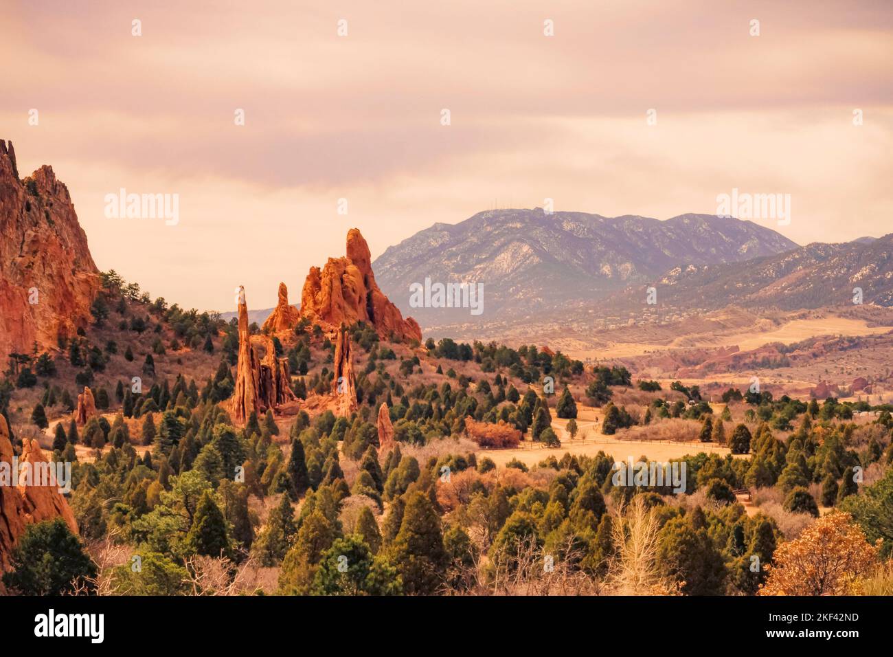 A landscape view of desert with hills, red cliffs and trees Stock Photo ...