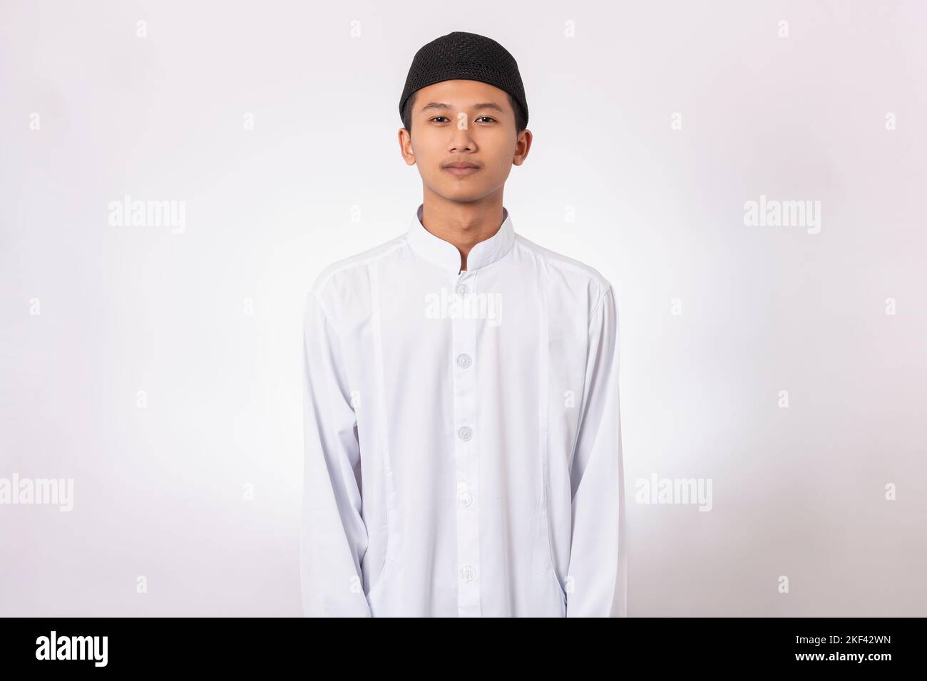Smiling Asian muslim man happy celebrating Eid Al-Fitr isolated white ...