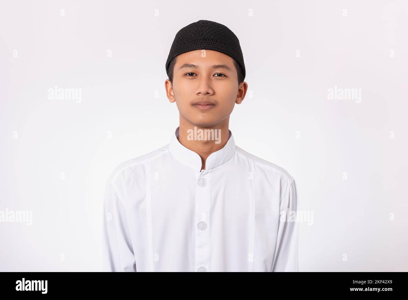 Smiling Asian muslim man happy celebrating Eid Al-Fitr isolated white ...