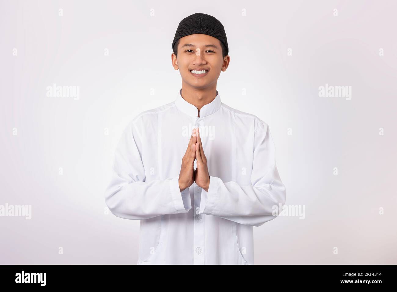 Smiling Asian muslim man happy celebrating Eid Al-Fitr isolated white ...