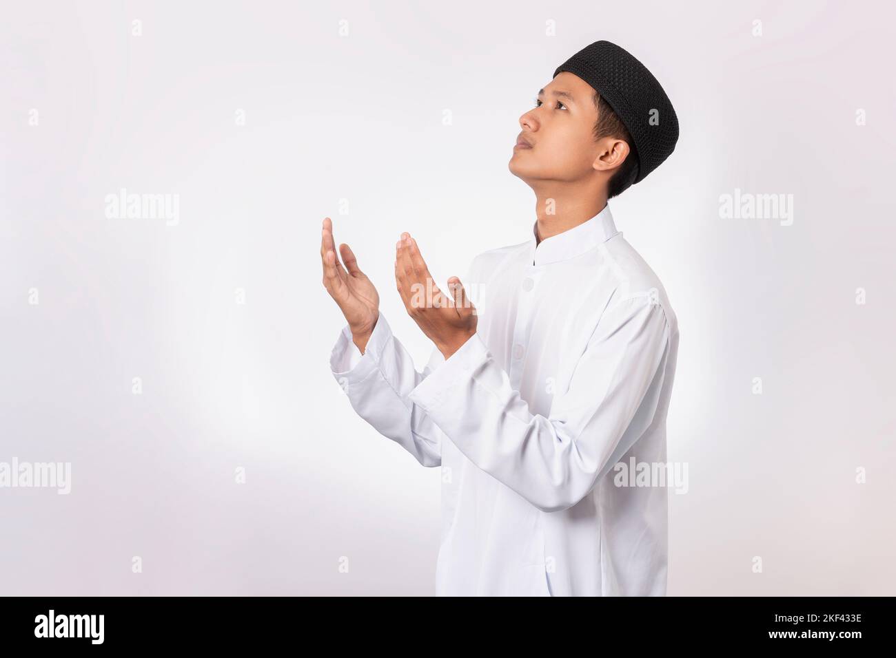 Smiling Asian muslim man happy celebrating Eid Al-Fitr isolated white ...