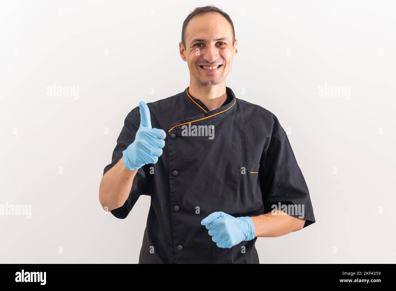 Image of caucasian male chief in uniform smiling while standing over ...