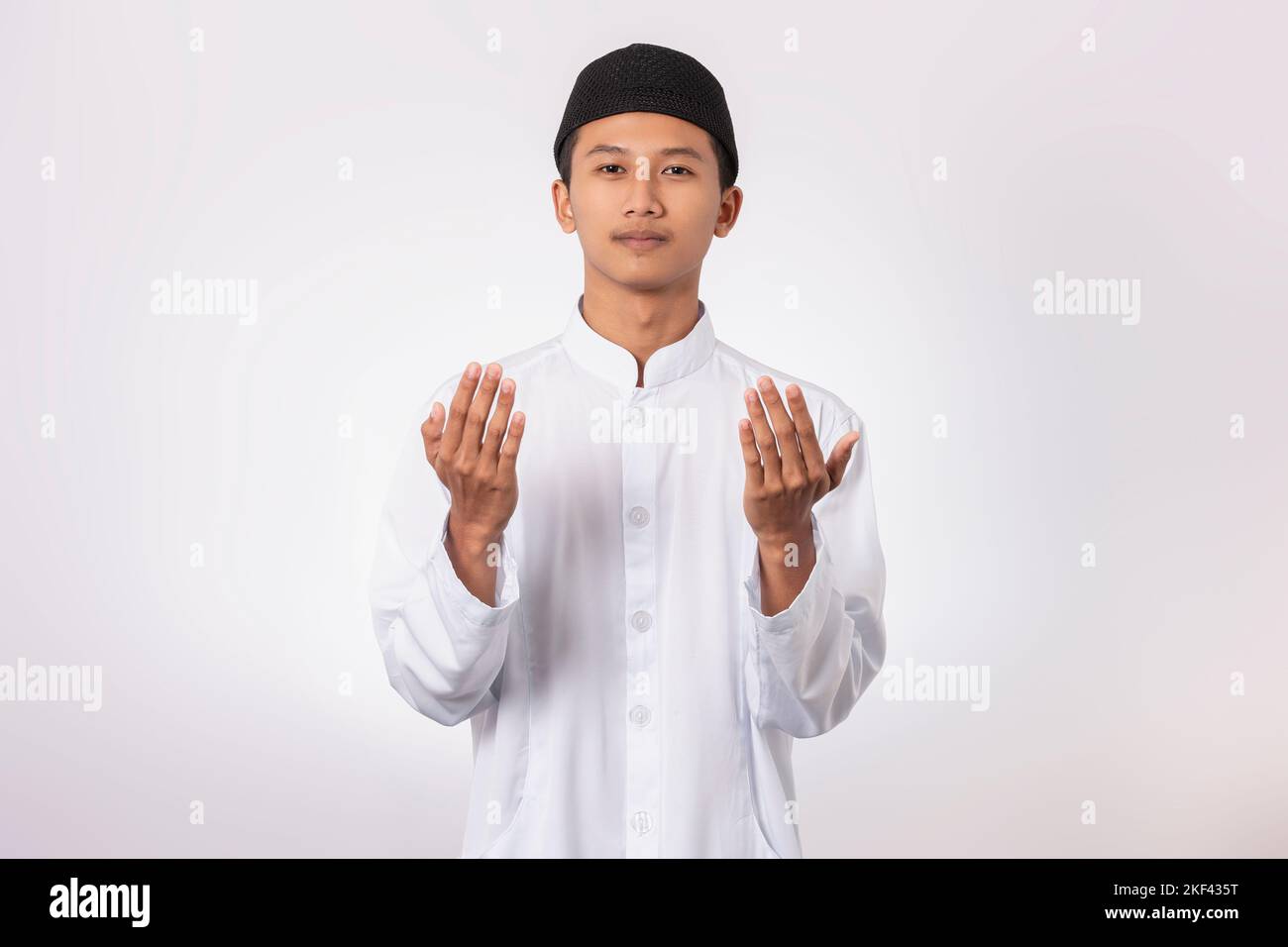 Smiling Asian muslim man happy celebrating Eid Al-Fitr isolated white ...