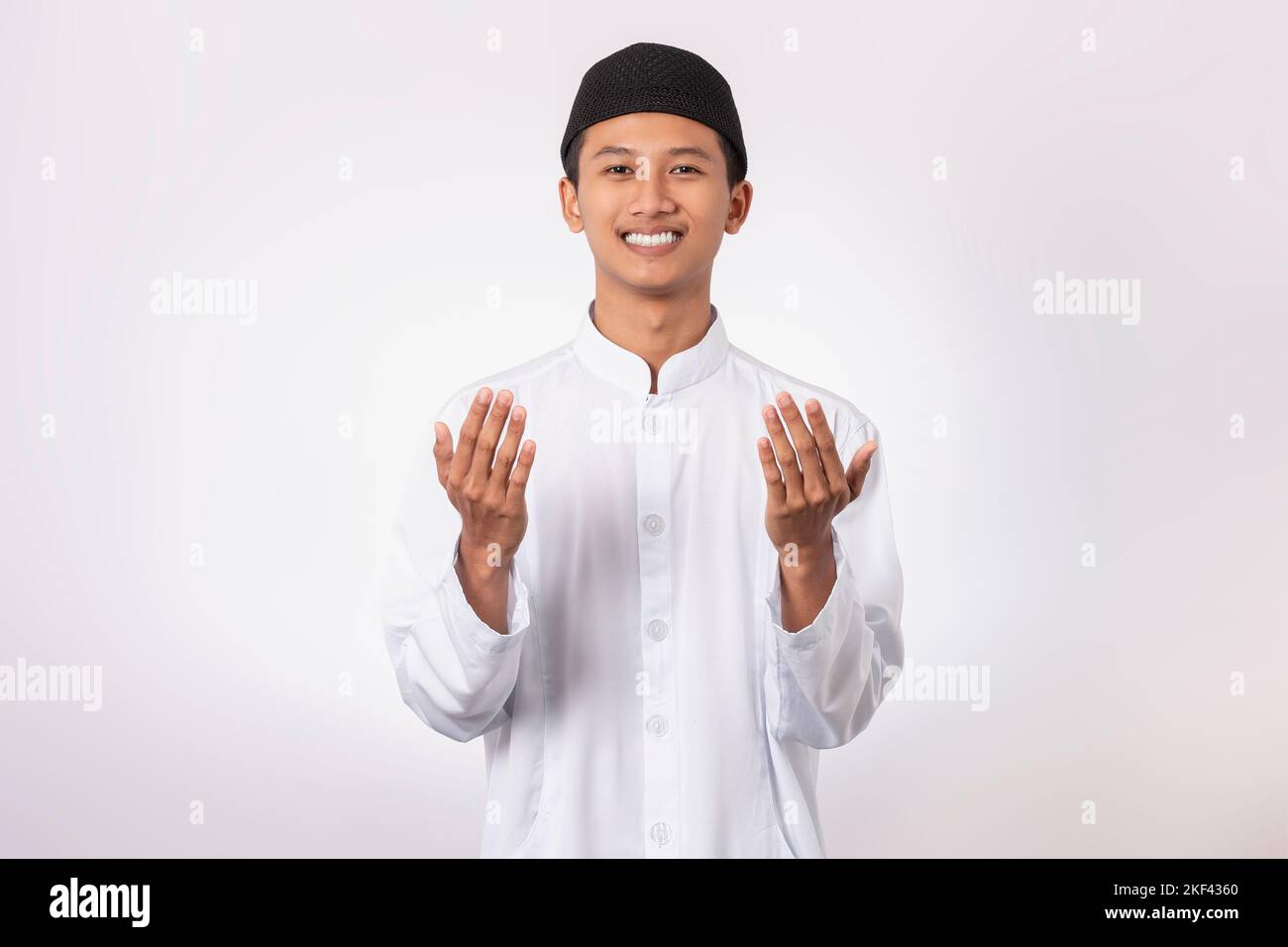 Smiling Asian muslim man happy celebrating Eid Al-Fitr isolated white ...