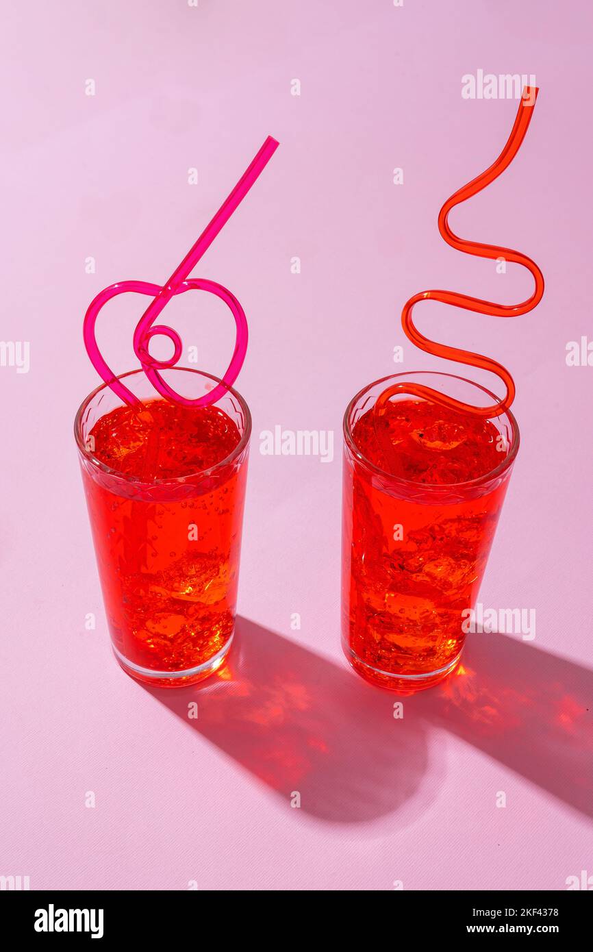 Summer drinks with straws on color background Stock Photo - Alamy