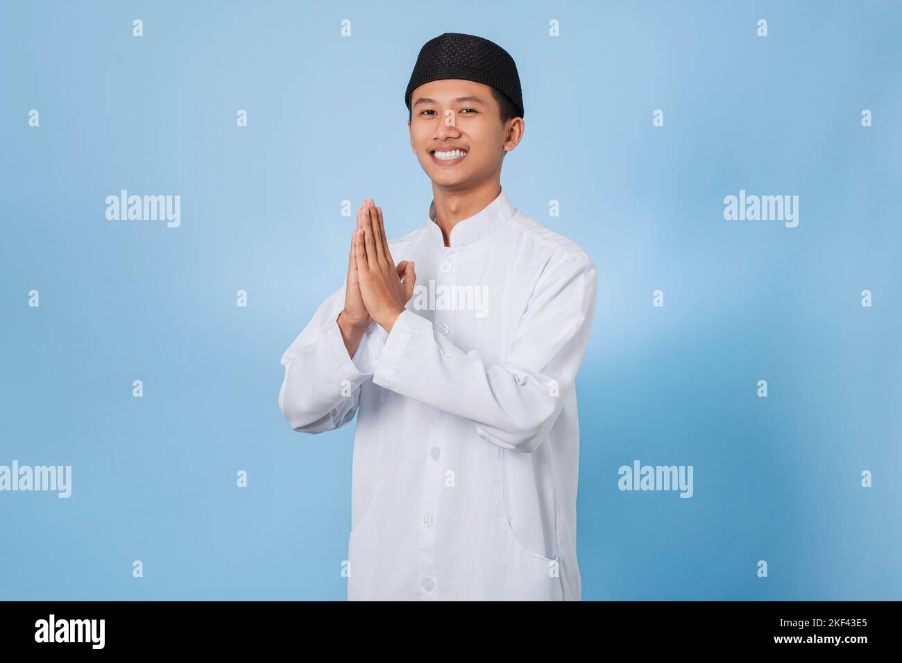 Smiling Asian muslim man happy celebrating Eid Al-Fitr isolated white ...