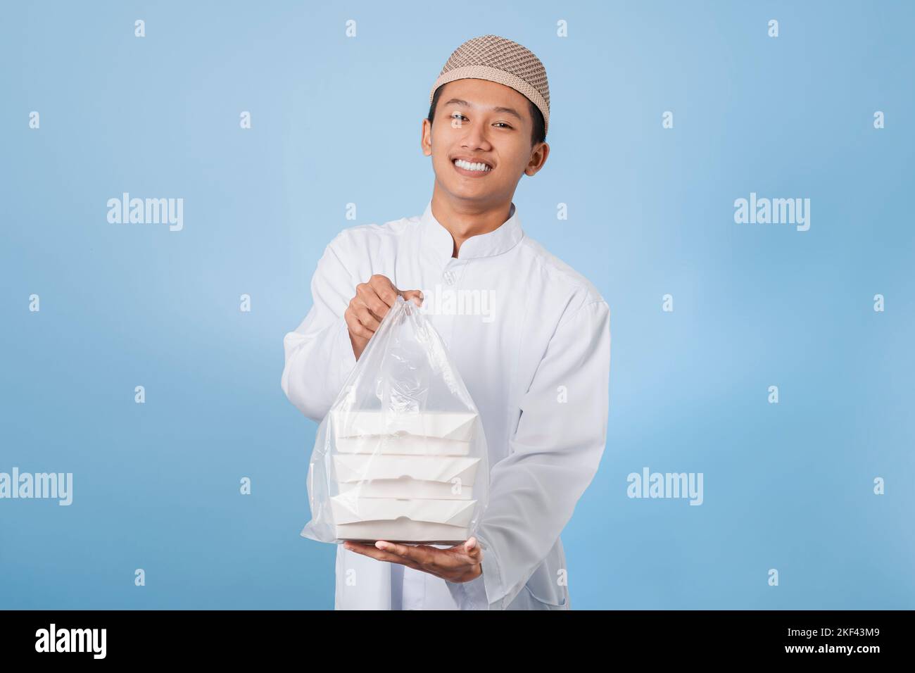 Smiling Asian muslim man happy celebrating Eid Al-Fitr isolated white ...