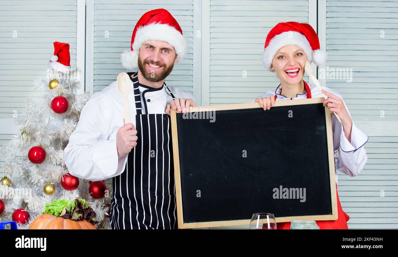 Menu for our family. Man and woman chef santa hat near christmas tree ...