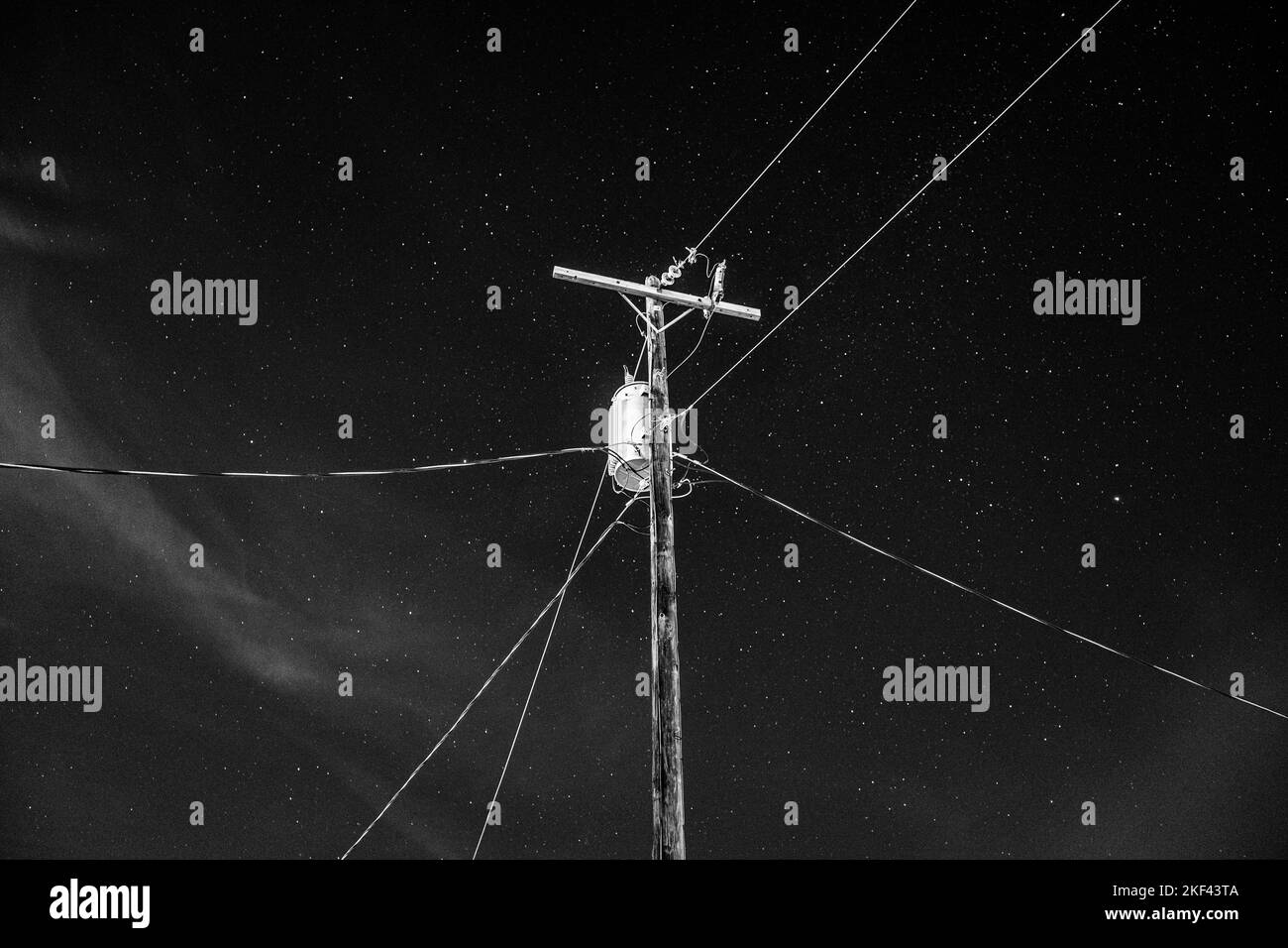 An electric pole with branches of electricity against the background of ...