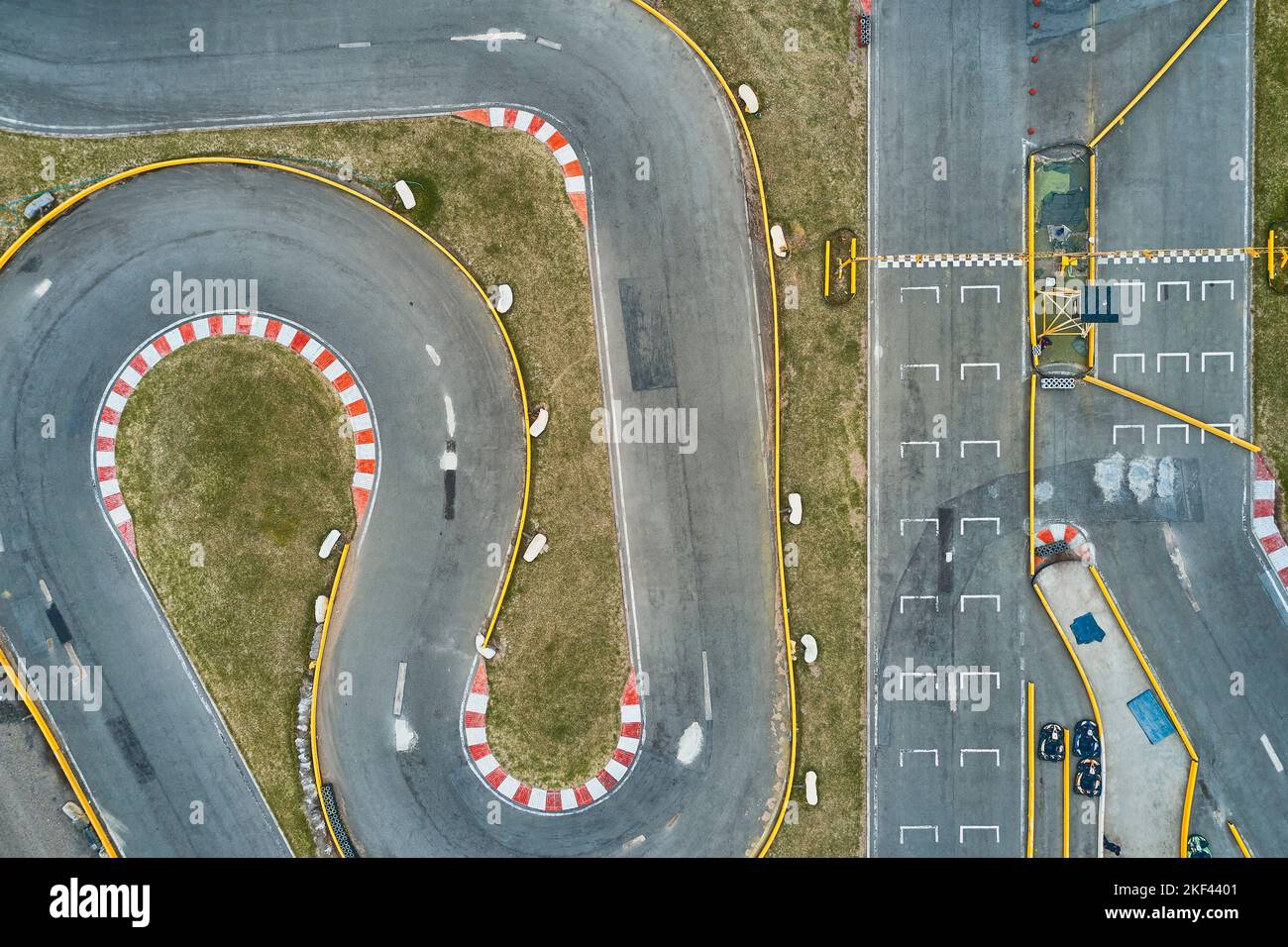 Aerial top view of the go-kart track from the drone. Kart racers drive ...