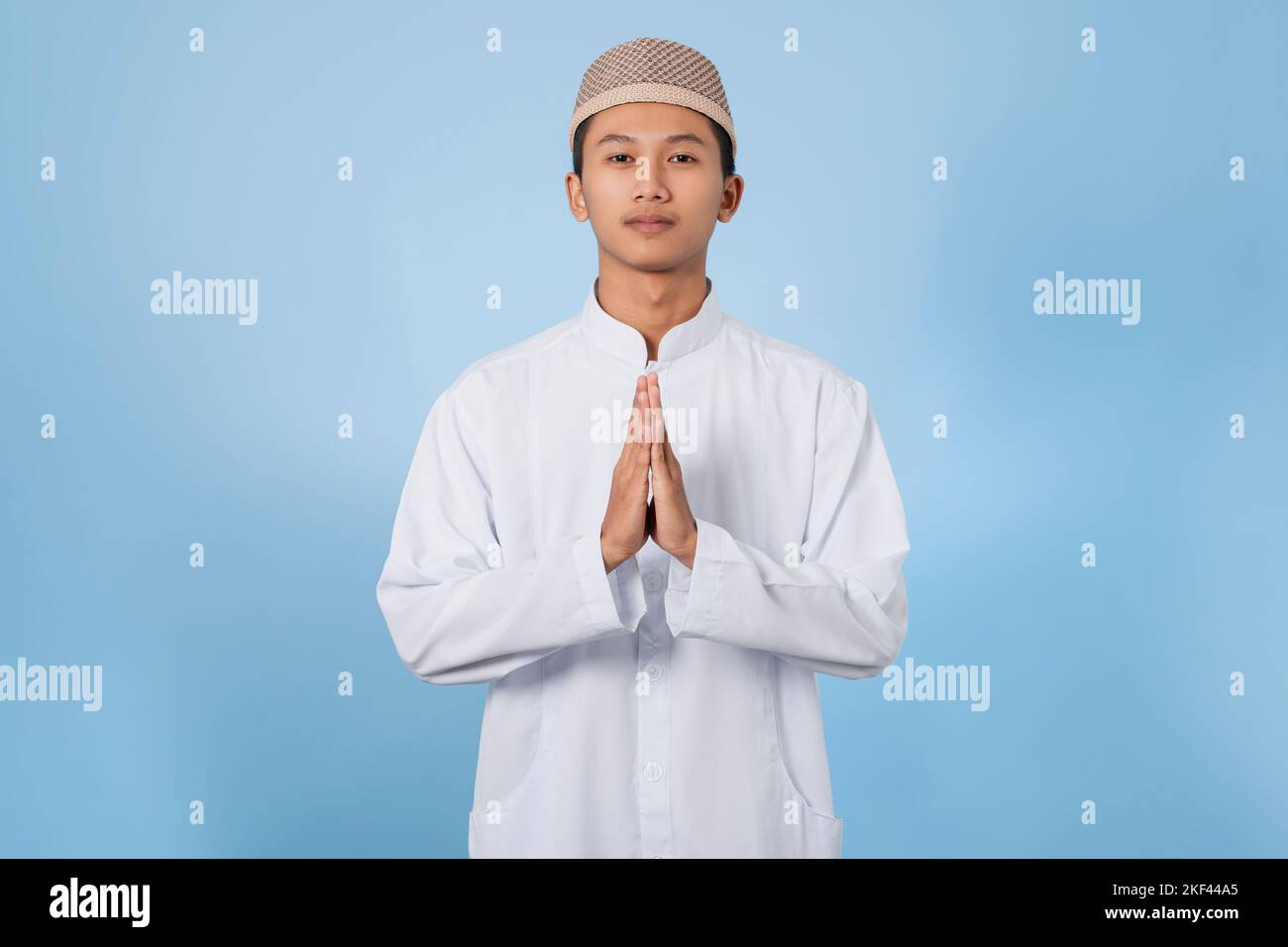 Smiling Asian muslim man happy celebrating Eid Al-Fitr isolated white ...
