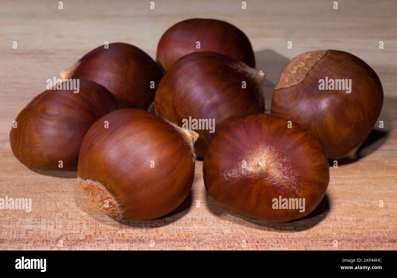 Group of chestnuts fresh from the tree on a wood table Stock Photo - Alamy