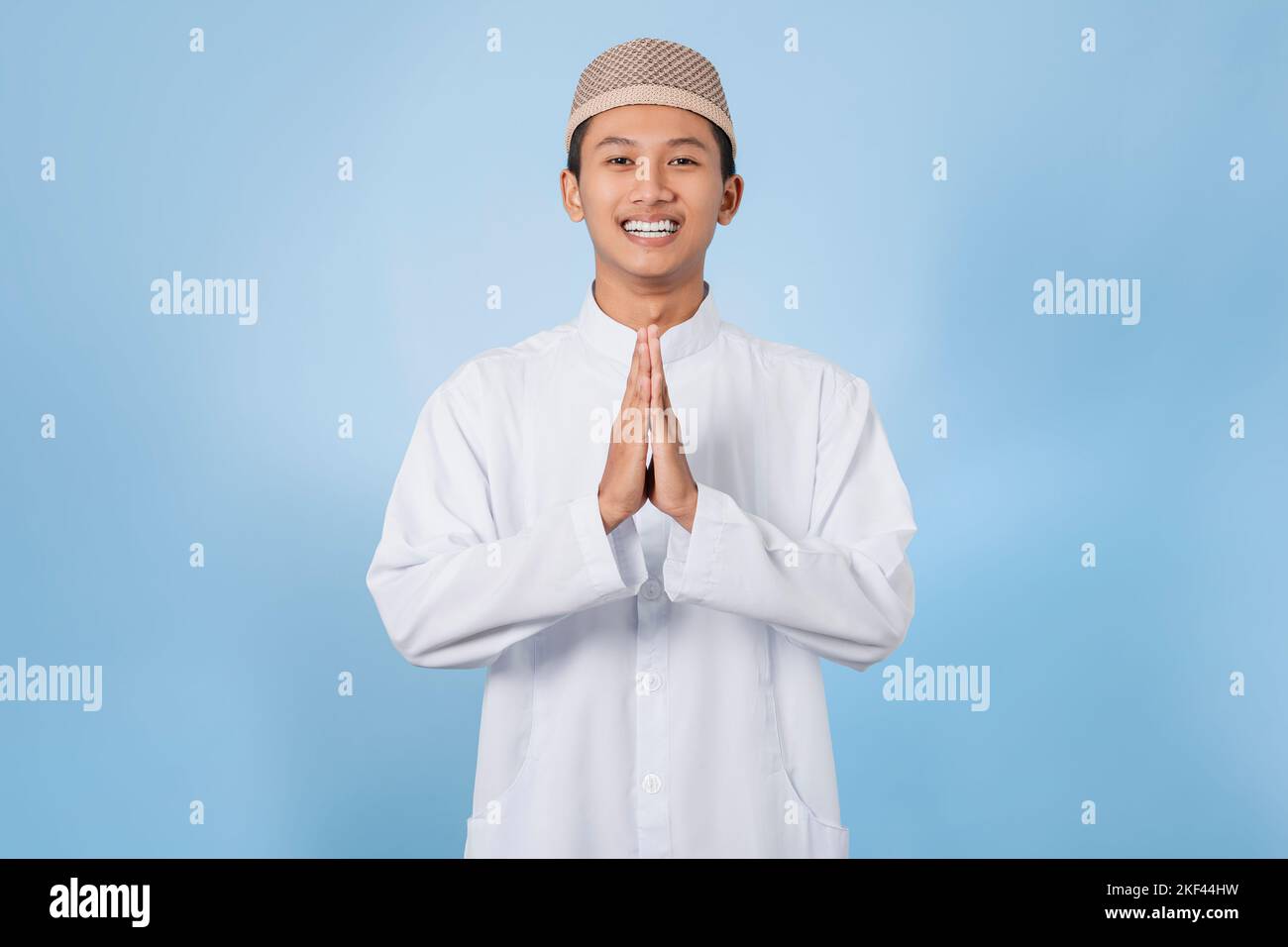 Smiling Asian muslim man happy celebrating Eid Al-Fitr isolated white ...
