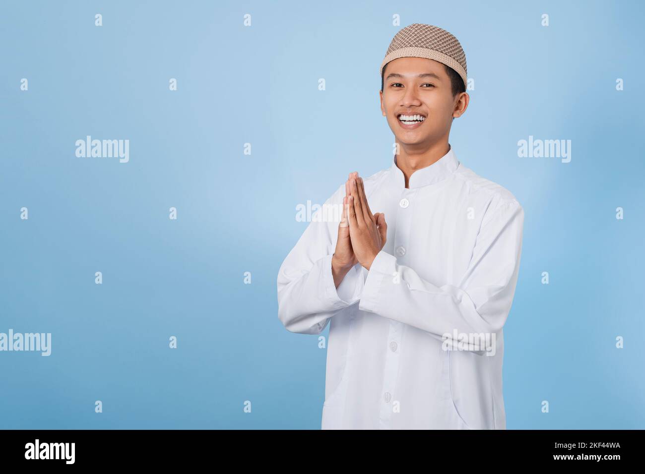 Smiling Asian muslim man happy celebrating Eid Al-Fitr isolated white ...
