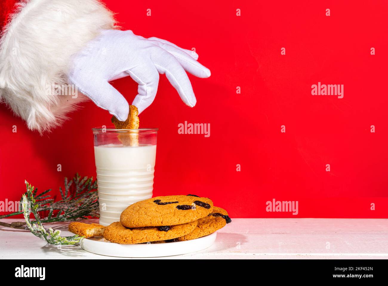 Hand of Santa Claus with traditional Christmas cookie snack with milk ...