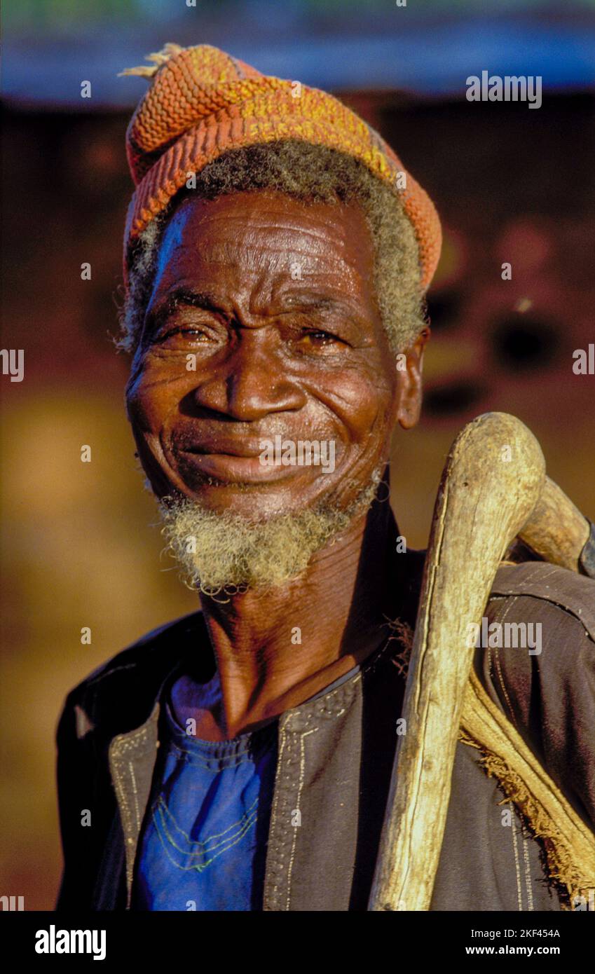 Burkina Faso. Portrait of a farmer. The man has just finished work in ...