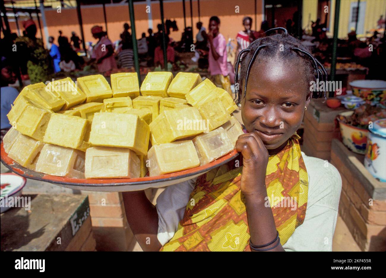 Burkina Faso,Piela. A girl is selling soap, made in a small factory ...