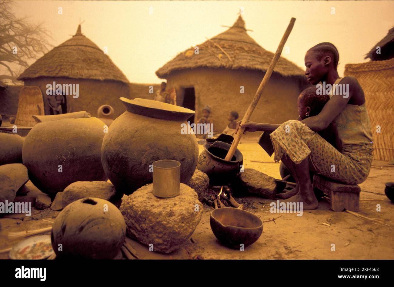 Burkina Faso, a woman of the Peuhl tribe is cooking within the village ...