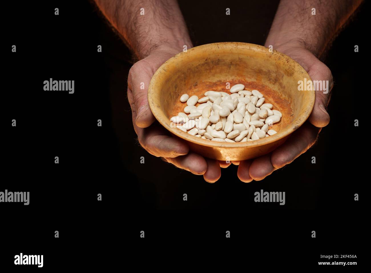 Male hands holding grains of dry kidney beans on dark background Stock ...