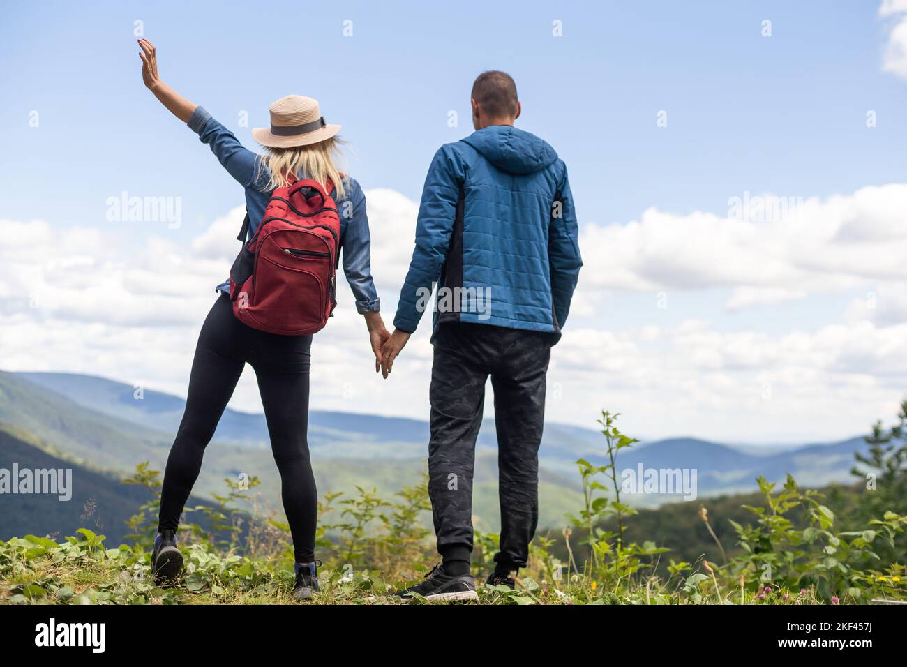 Portrait of beautiful young couple enjoying nature at mountain peak Stock Photo - Alamy