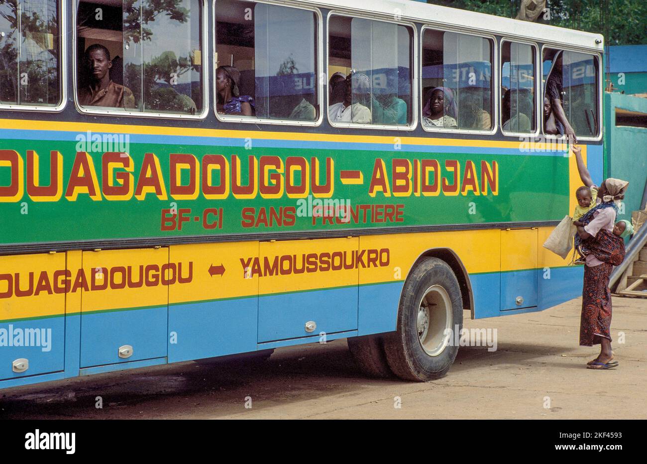 Burkina Faso, Ouagadougou; Woman carrying her children saying good-bye ...
