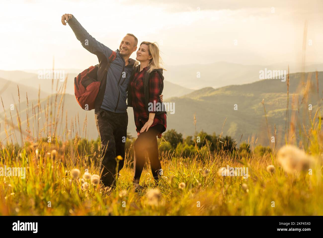 beautiful young couple enjoying nature at mountain Stock Photo - Alamy