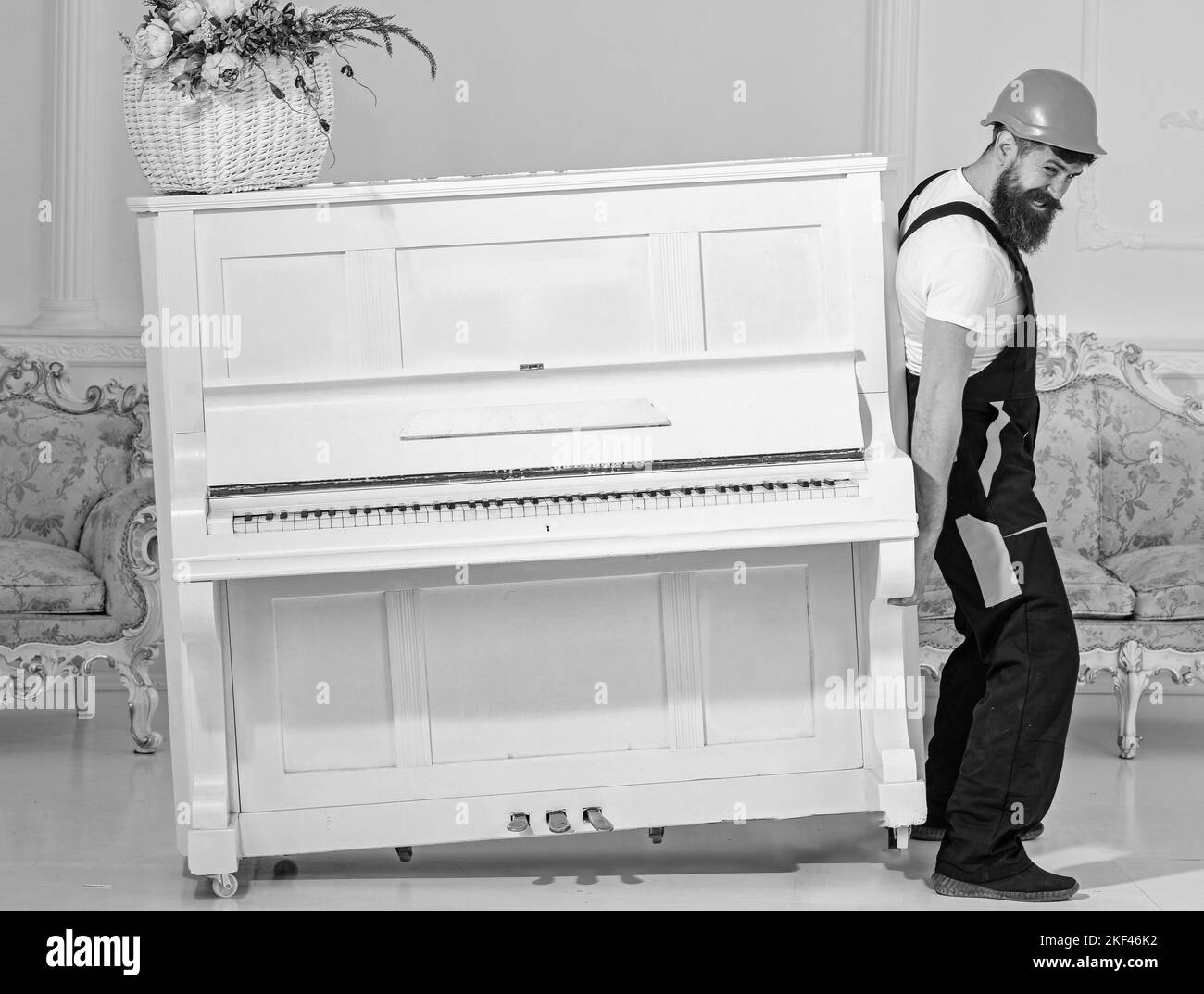 Loader moves piano instrument. Courier delivers furniture in case of ...