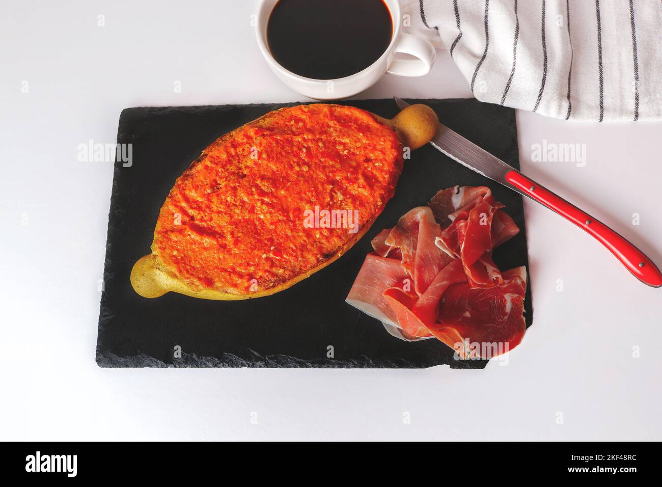 slice of bread with tomato, iberian ham and a cup of coffee typical ...