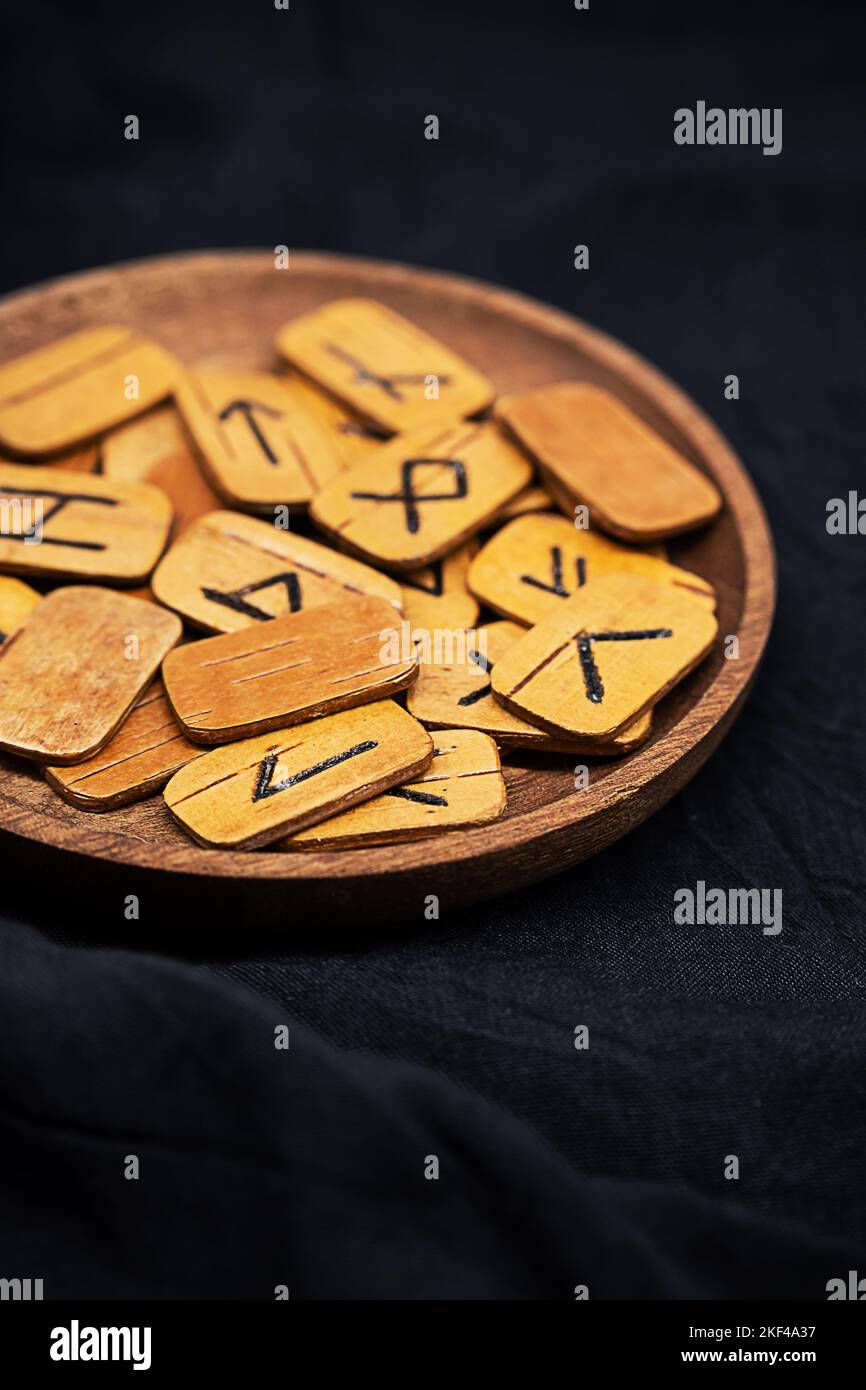 Handmade wooden runes on black fabric. Heap of Scandinavian runes for ...