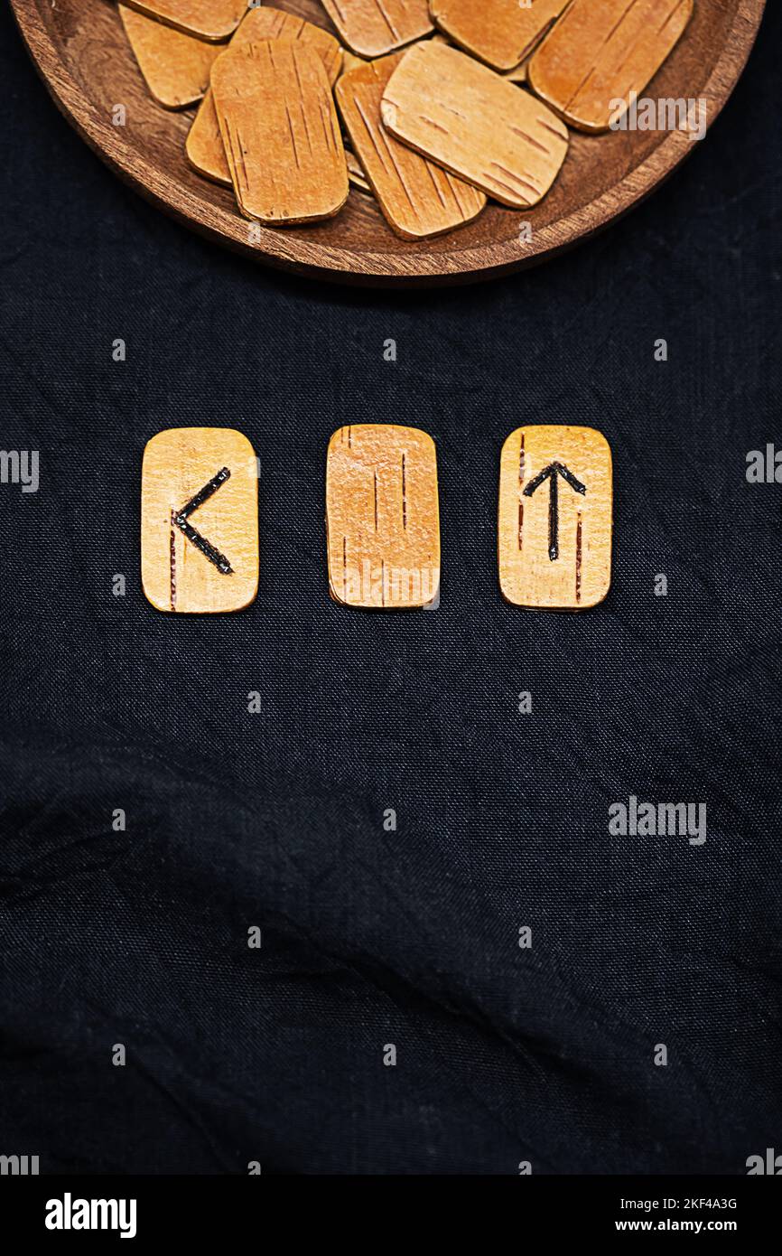 Handmade wooden runes on black fabric. Heap of Scandinavian runes for ...