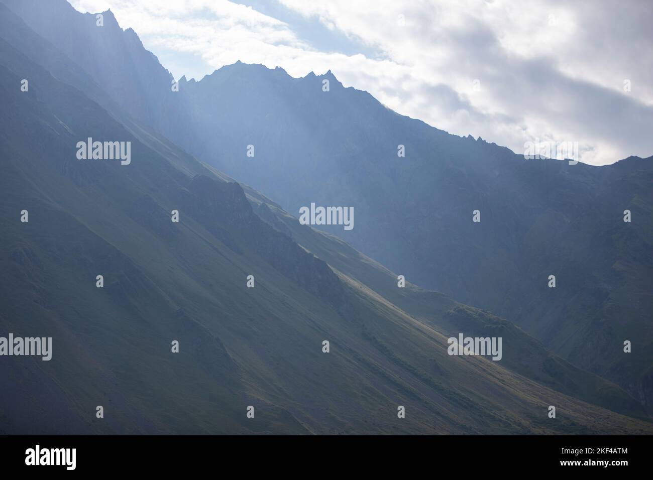 Dark atmospheric surreal landscape with a dark rocky mountain peak in ...