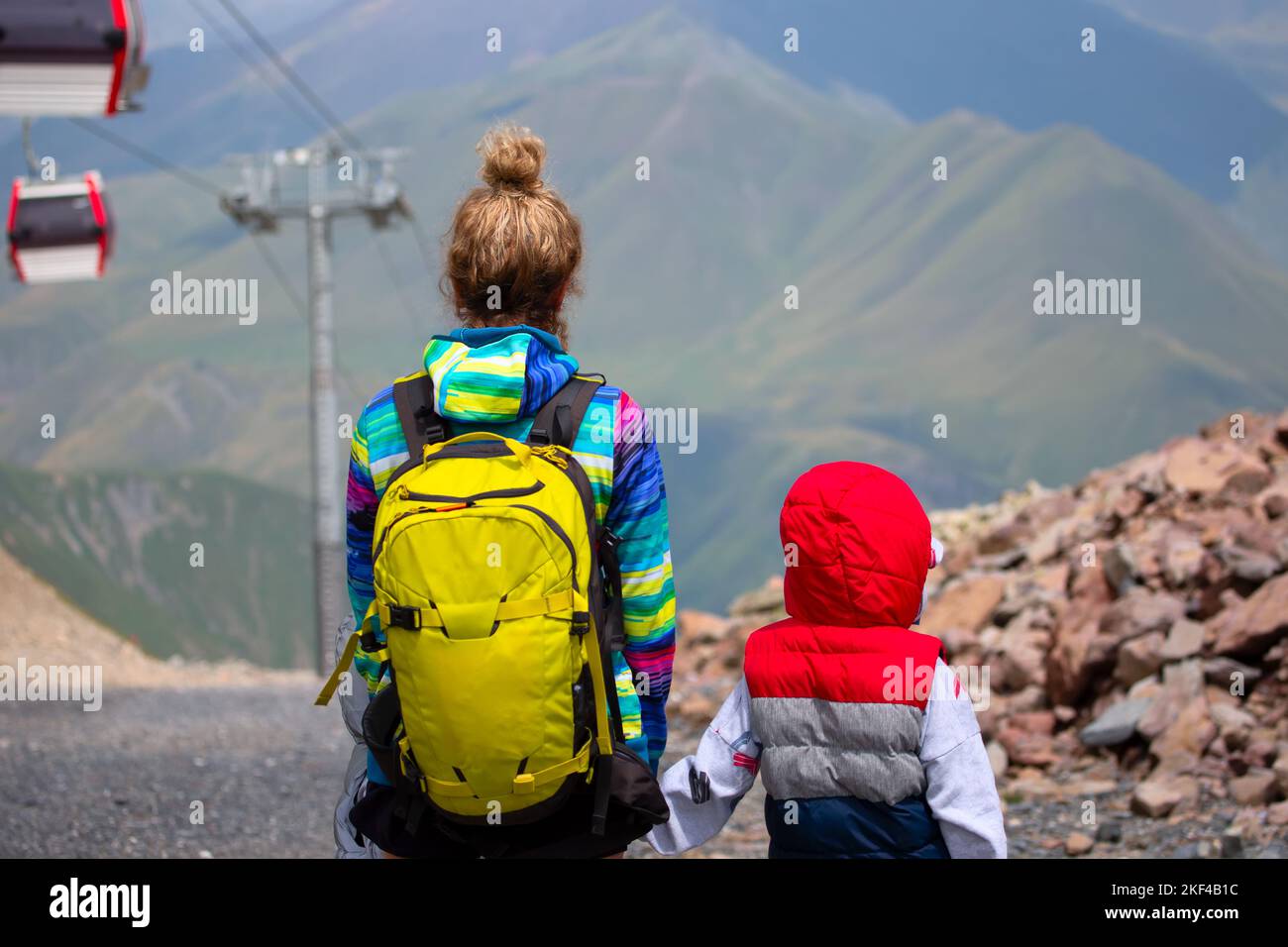 Mom with a child, the family travels through the mountains, rides the ...