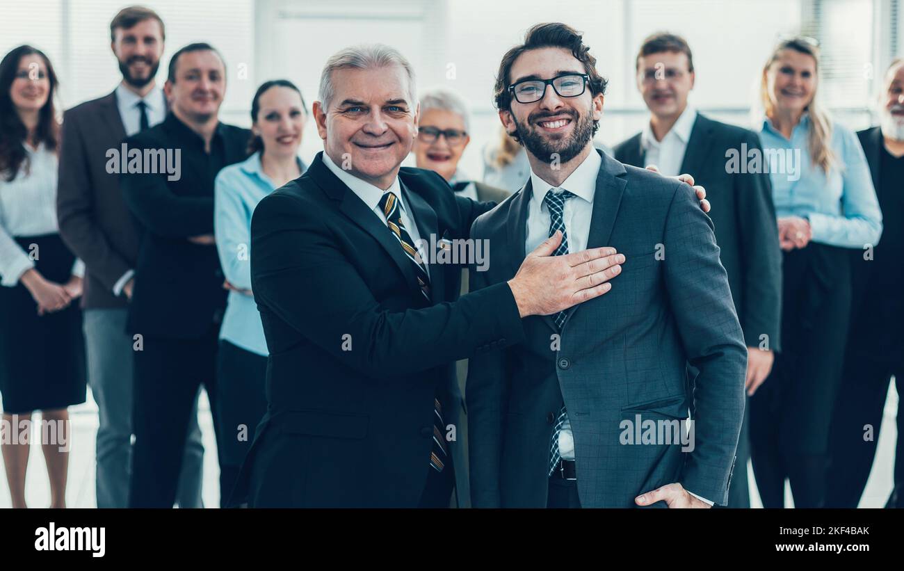 Manager congratulating the best employee at the meeting Stock Photo - Alamy