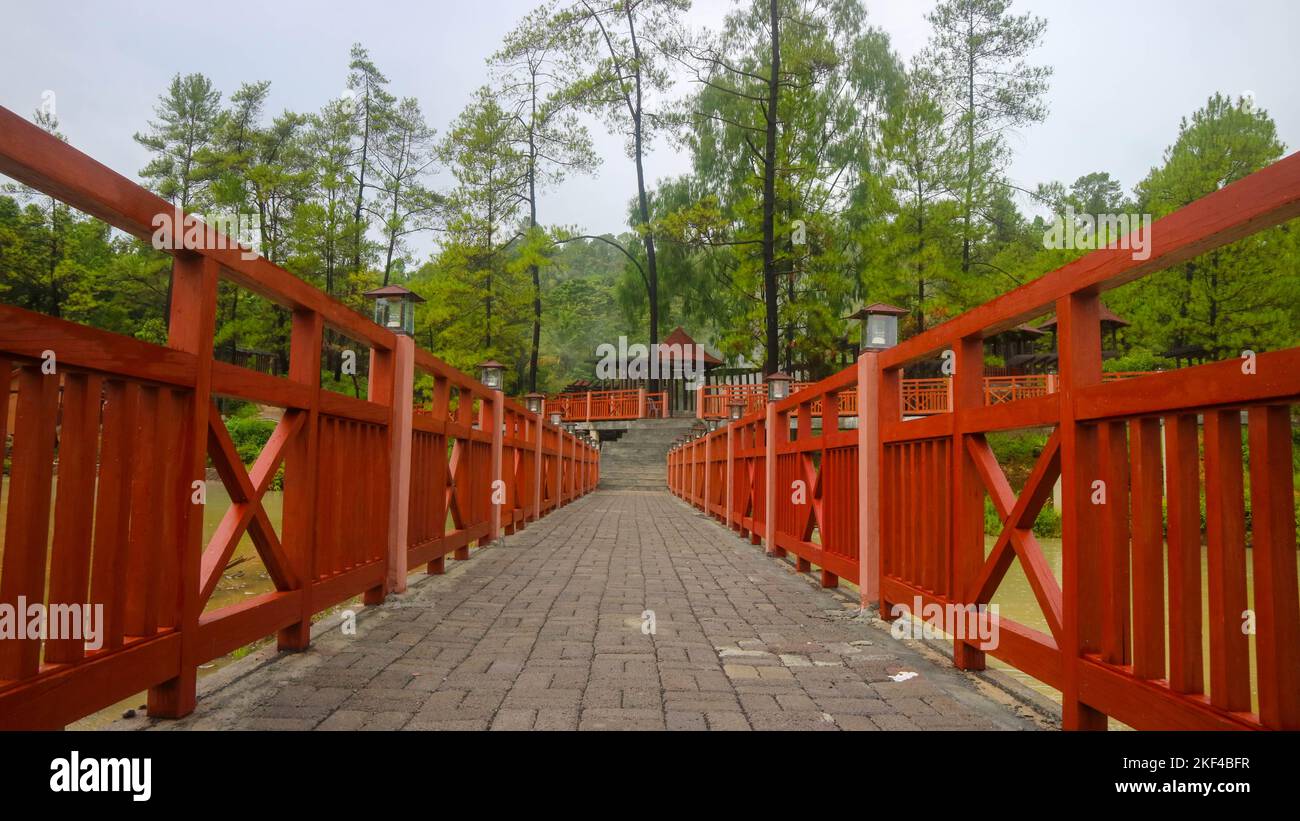 red bridge over the hot spring lake Stock Photo - Alamy