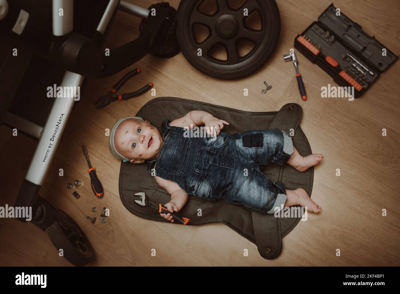 Mechanic baby boy repairing his baby stroller. Humor. Kid with tools ...