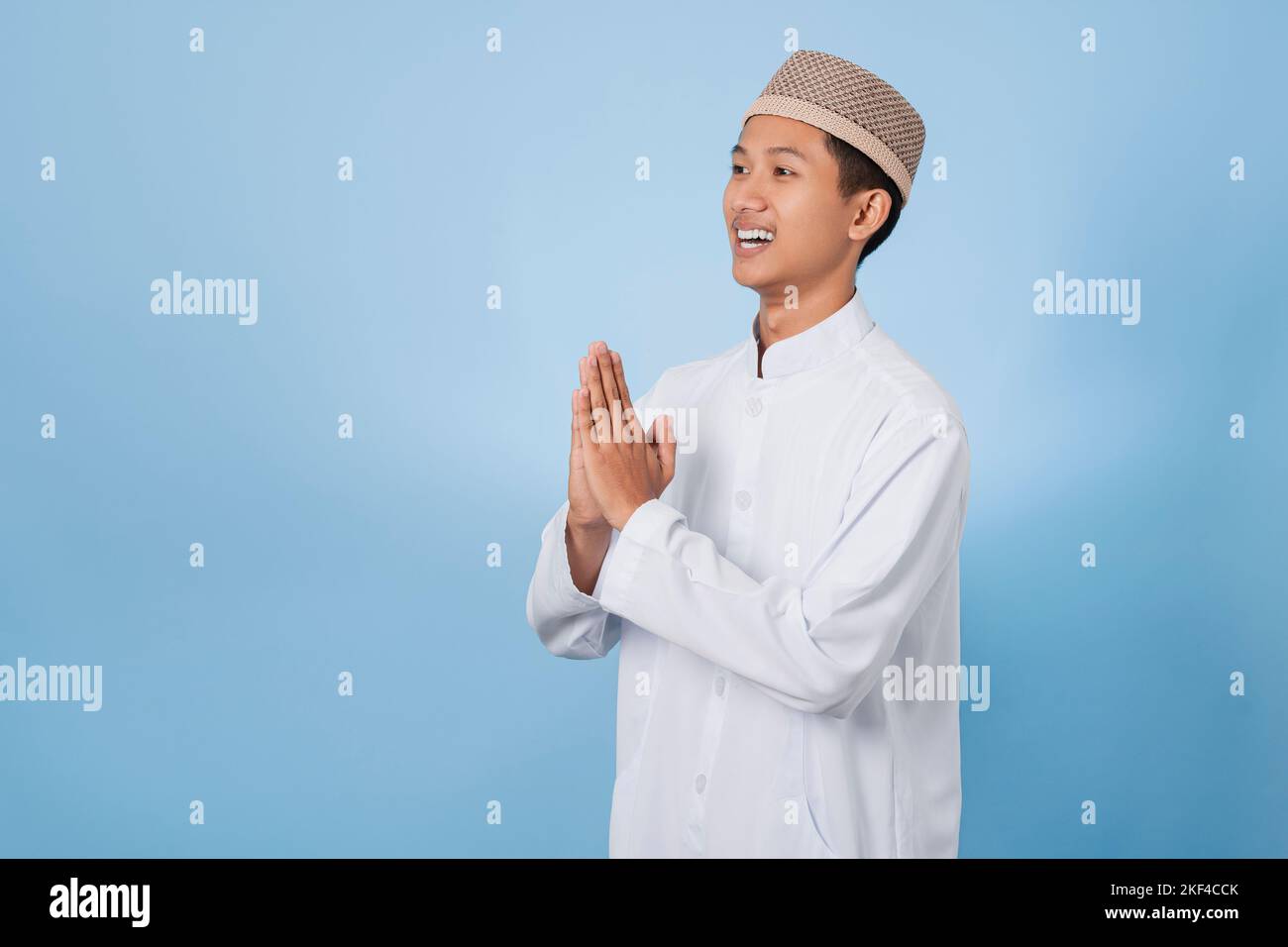 Smiling Asian muslim man happy celebrating Eid Al-Fitr isolated white ...