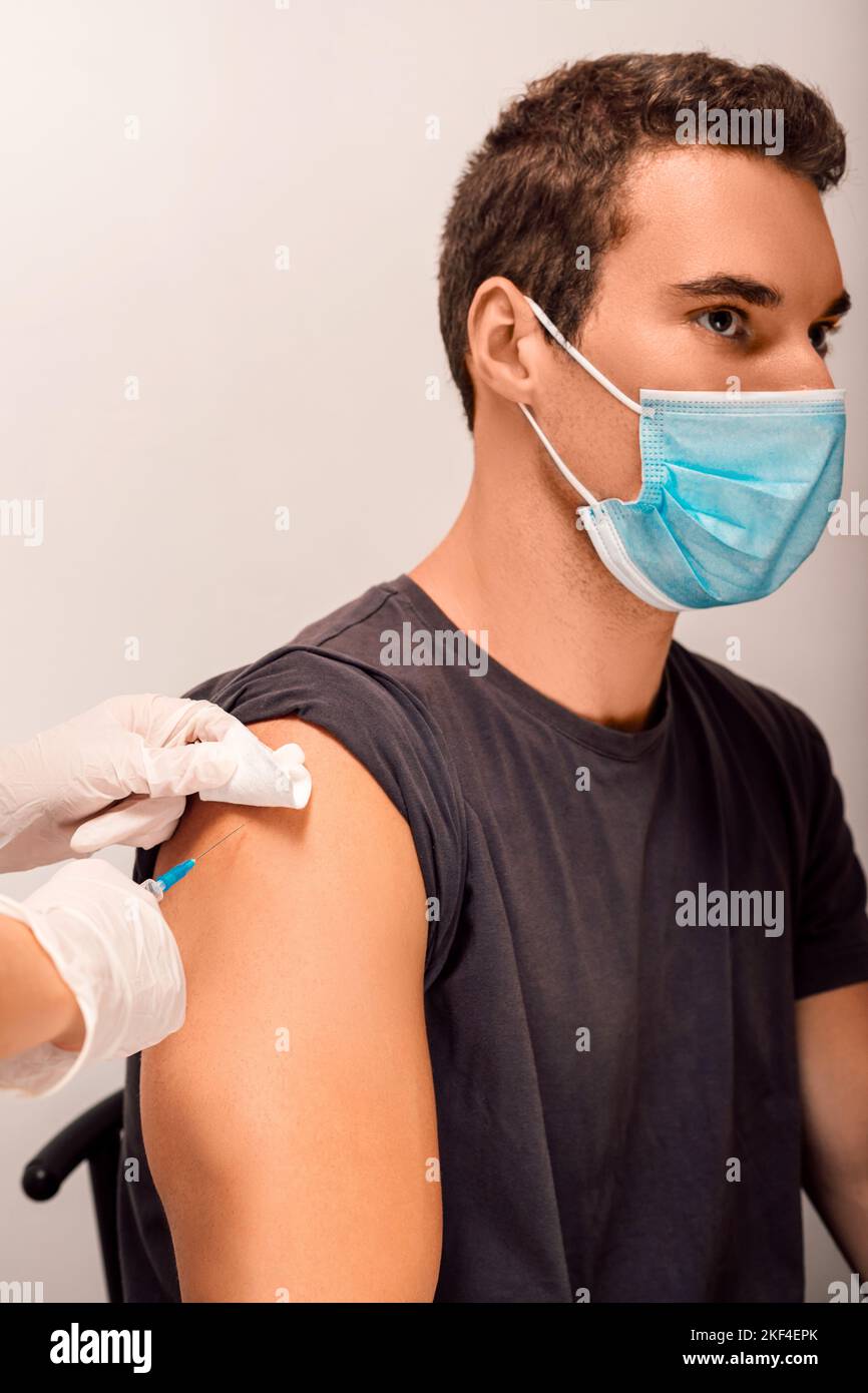The man is vaccinated. Doctor's hands with a syringe and a man Stock ...