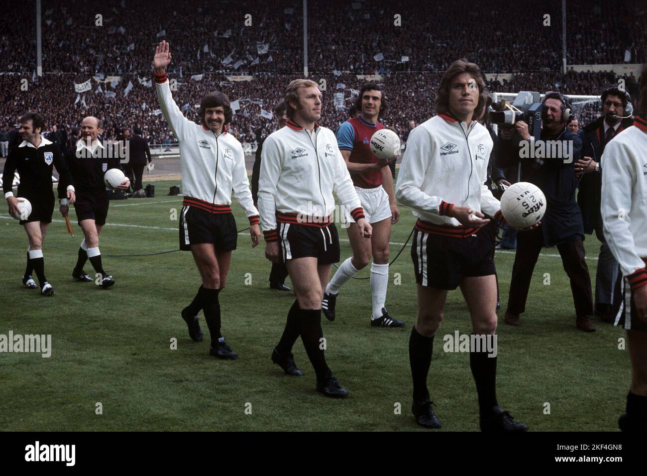 Fulham players (l-r) Alan Slough, Bobby Moore and John Mitchell walk ...