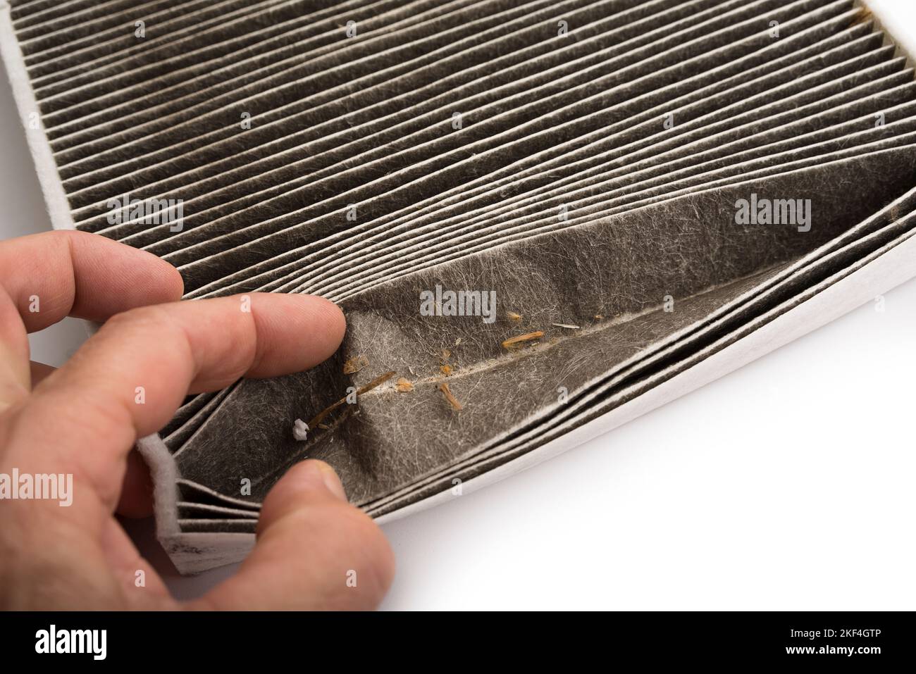 Dirty cabin filter open with a hand on a white Stock Photo - Alamy