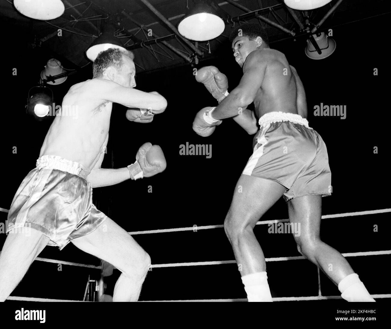 Both boxers raise their guards as they parry blows, during the ...