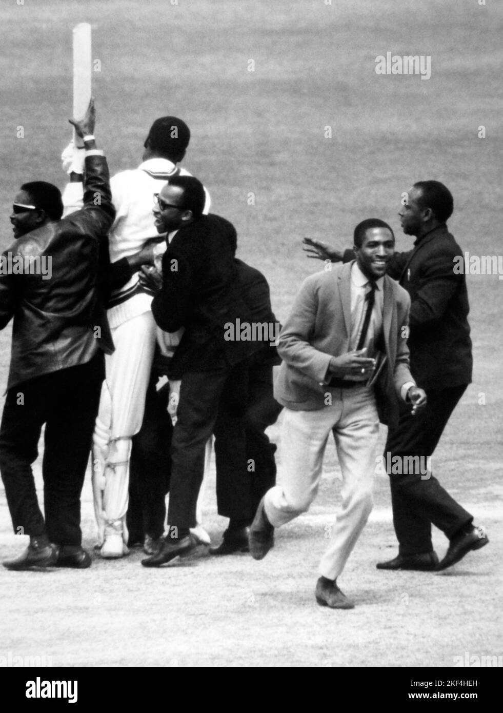 West Indies supporters rush onto the wicket and lift David Holford in ...