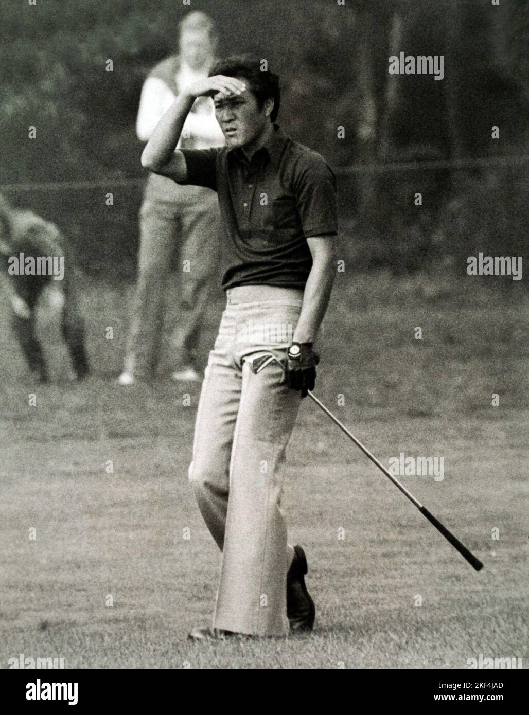 Japan's golf star Isao Aoki peers through the mist during play Stock ...