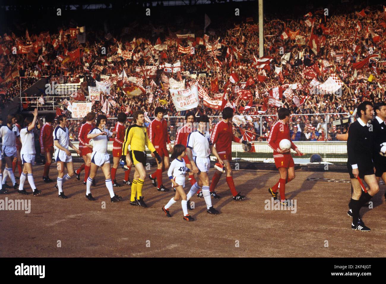 Liverpool captain Emlyn Hughes (far right) and Club Brugge captain Fons ...