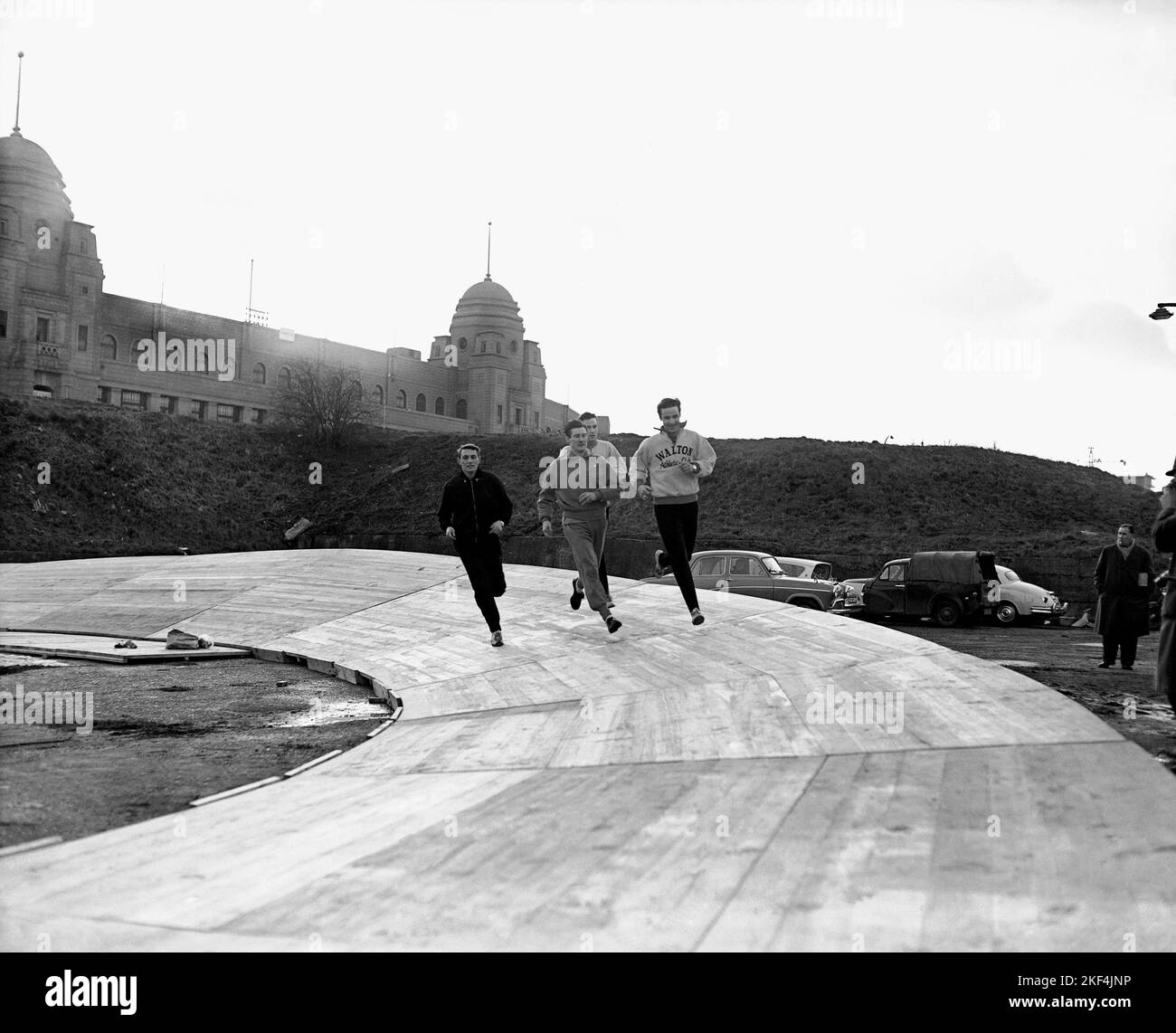 Athletes trying out one of the banked turns of the indoor wooden track ...