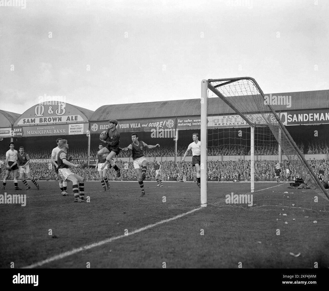 Bill Brown, the Tottenham goalkeeper jumps high to save from Ray ...