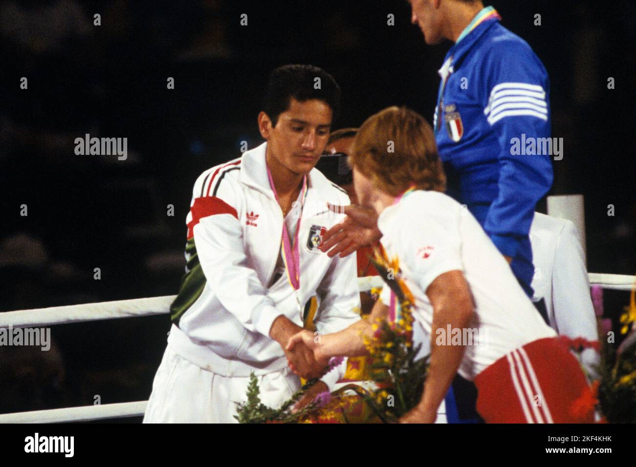 On the podium Hector Lopez silver medalist (Mexico) shakes the hand of ...