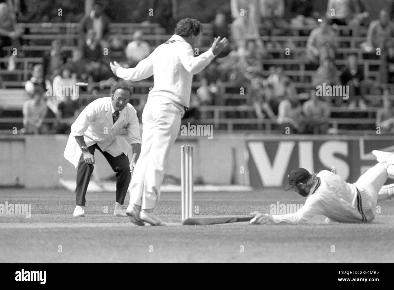 John Emburey, of Middlesex, watches the bails fly as Surrey's opening ...