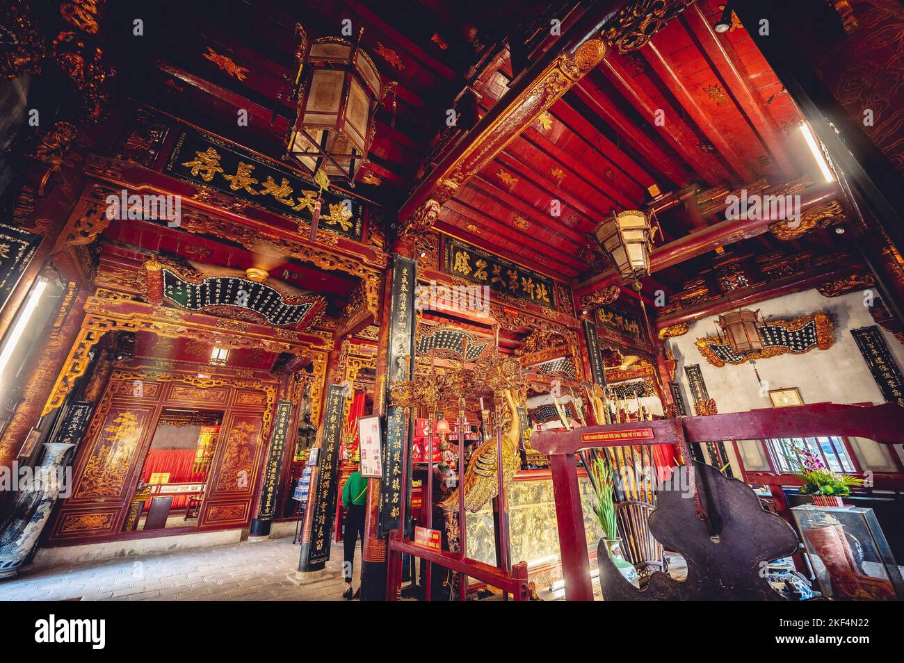 A beautiful shot of the interior of a Buddhist temple with altars and ...